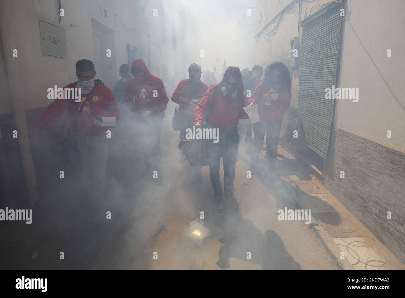 Members of the Nino Resucitado Brotherhood throw firecrackers during ...