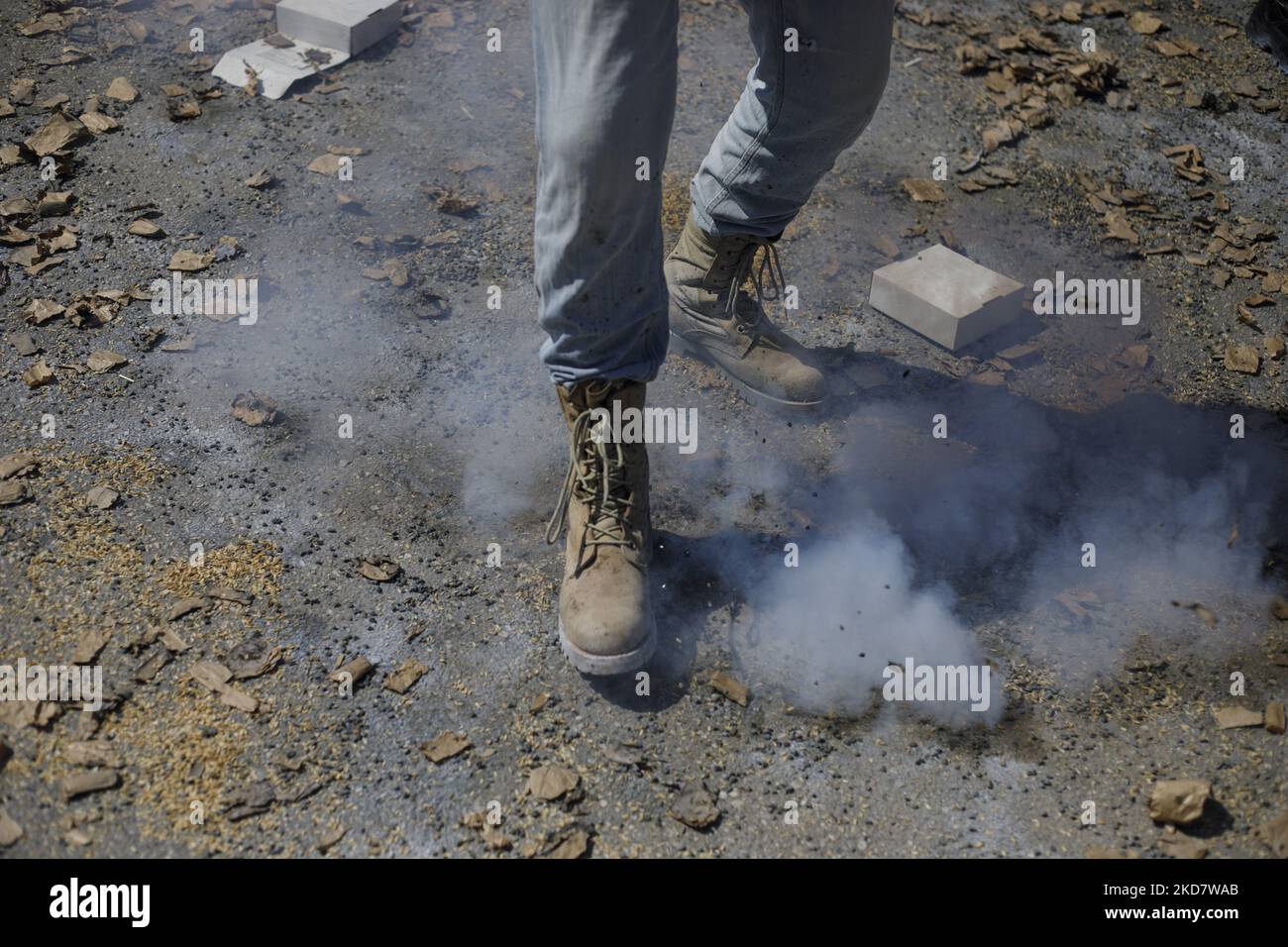 A Member of the Nino Resucitado Brotherhood step on a firecracker ...