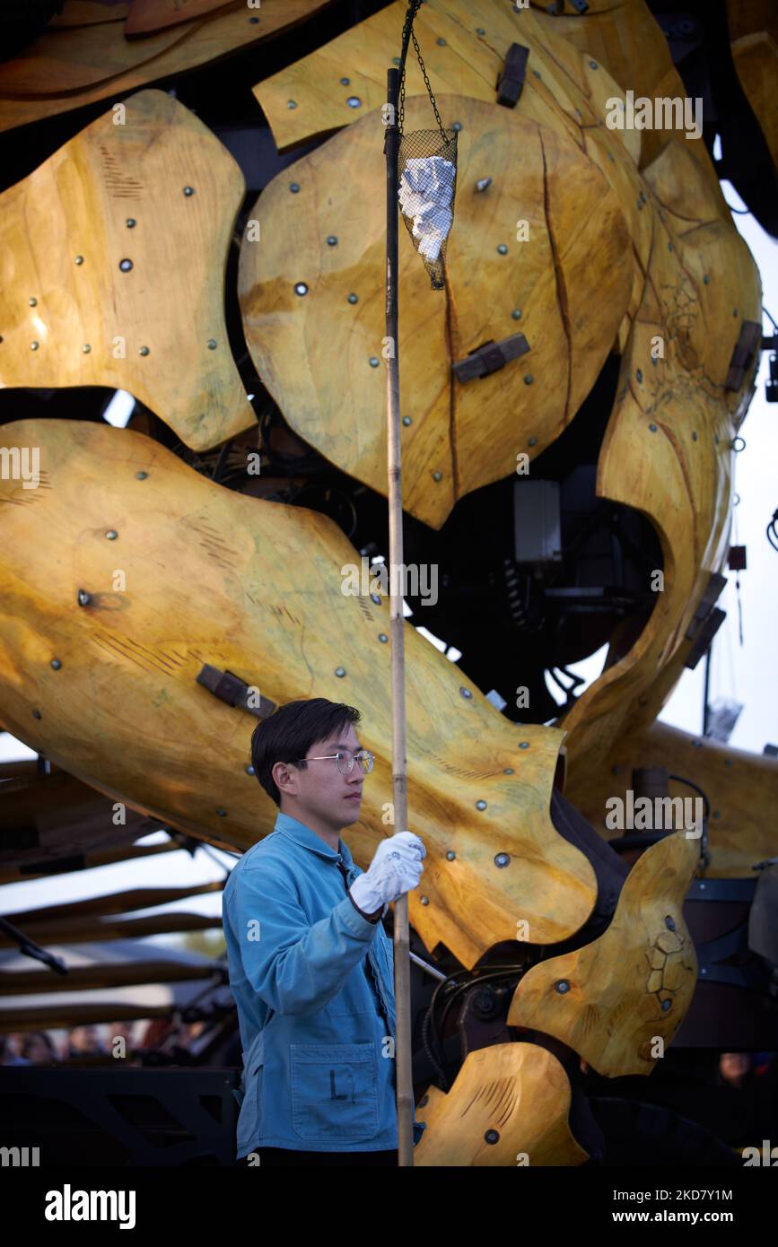 An operator stands guard near Long-Ma. A robot, a mare-dragon called ...