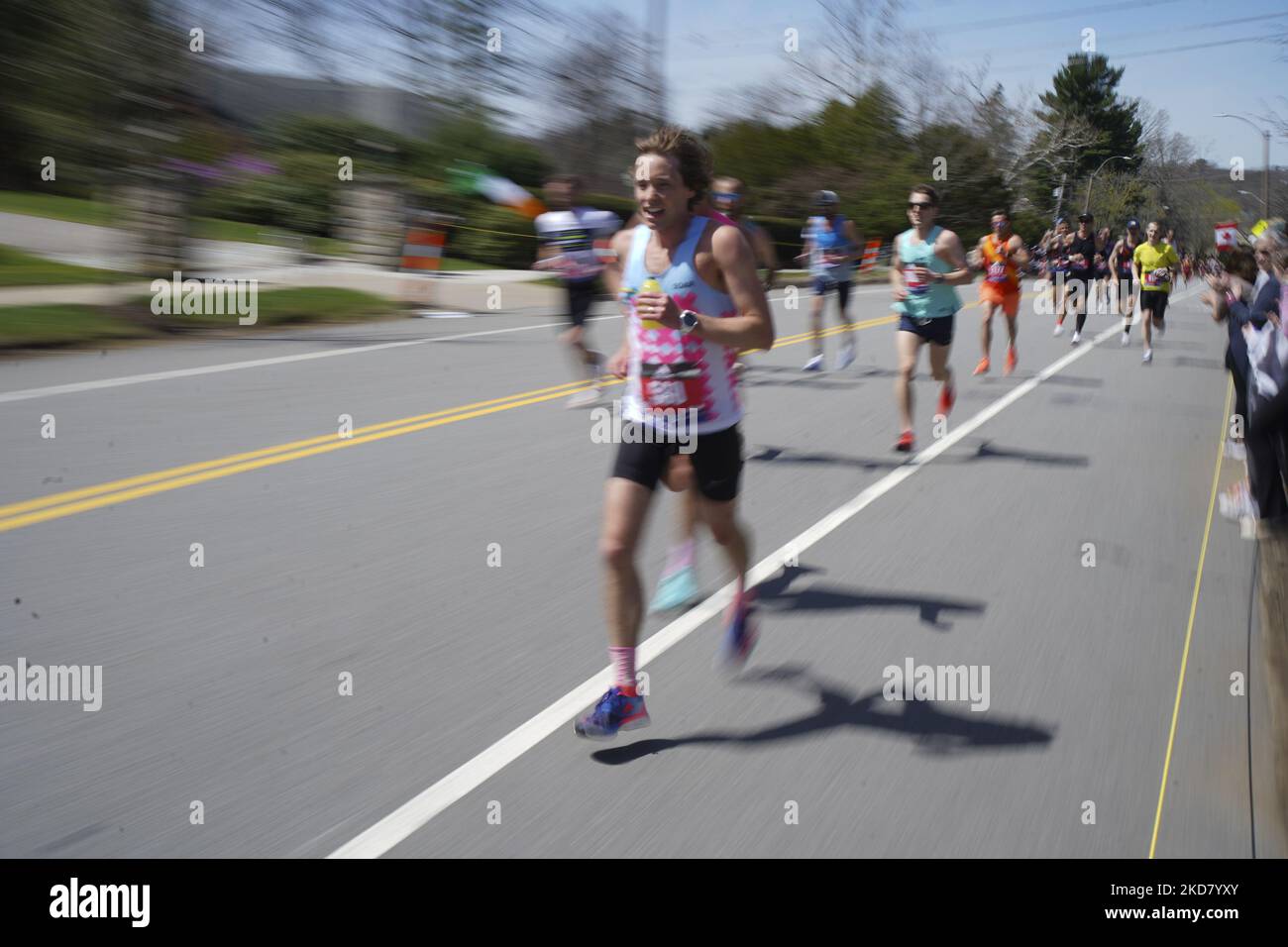 Runners pass through mile 17 in Newton, Massachusetts while running the ...