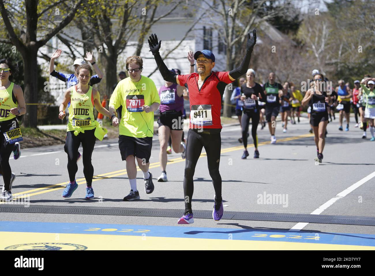 Runners pose for photographers as they pass kilometer 30 of the 2022 ...