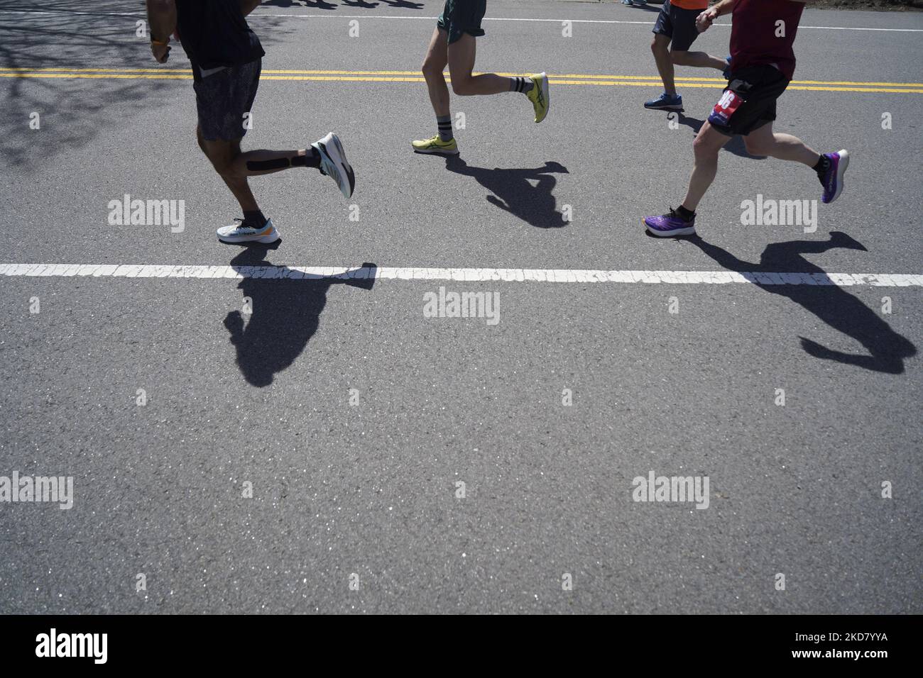 Runners pass through mile 17 in Newton, Massachusetts while running the ...