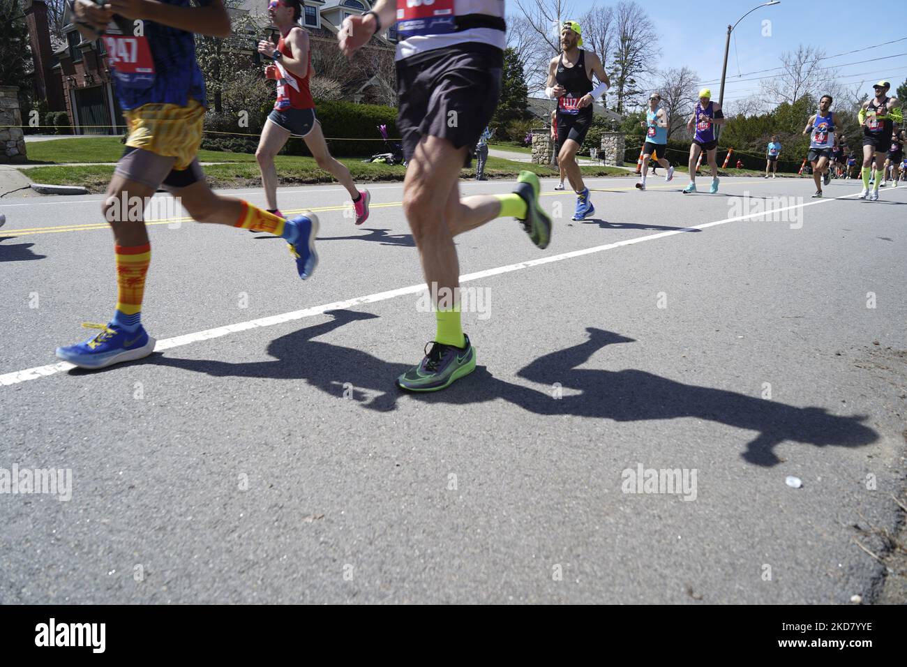 Runners pass through mile 17 in Newton, Massachusetts while running the ...