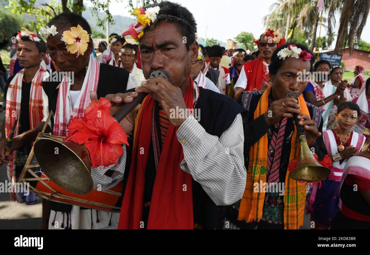A Karbi tribal plays a traditional instrument during a religious ...