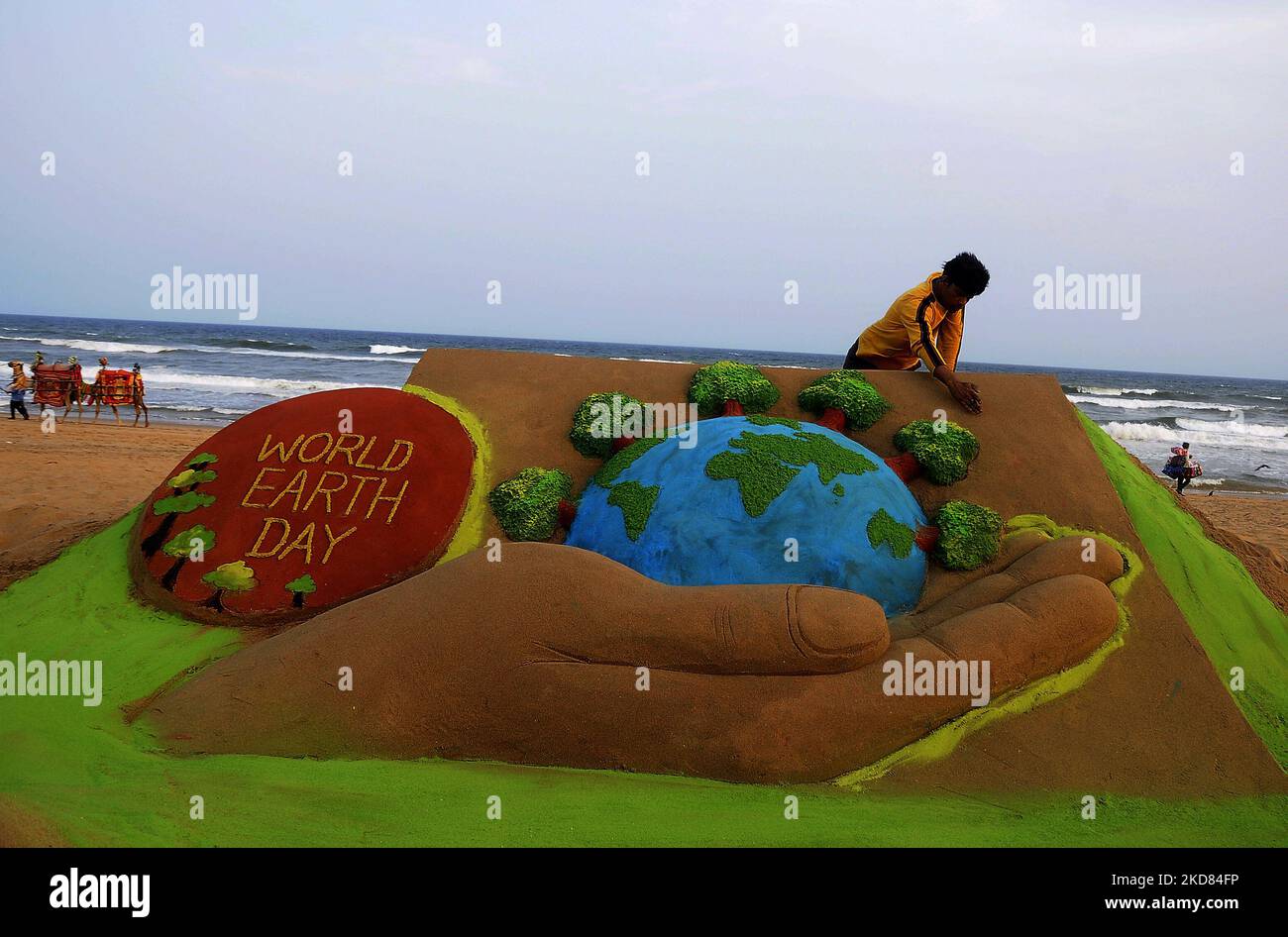 Sand artist Manas Sahoo gives his finishing touches to his sand ...