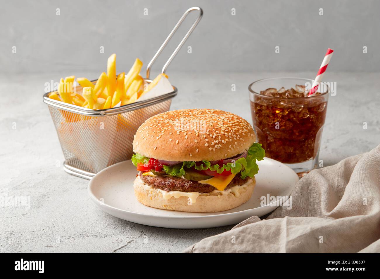 Fresh tasty burger, french fries and soft drink on dark background ...
