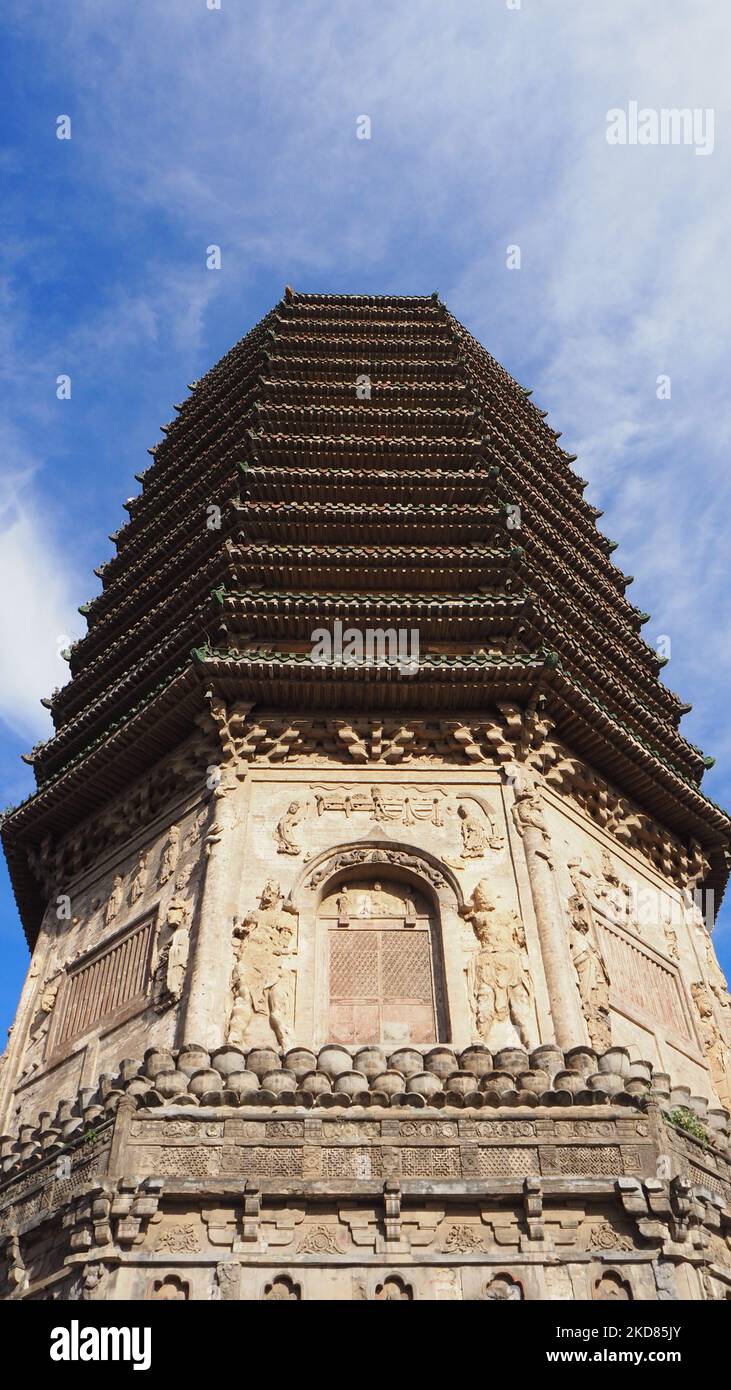 A vertical shot of a Chinese temple architecture in sunlight in blue ...