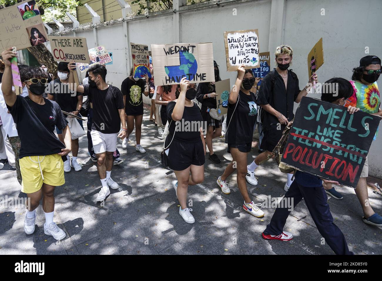 Environmental activists hold signs and shout slogans as they march on ...