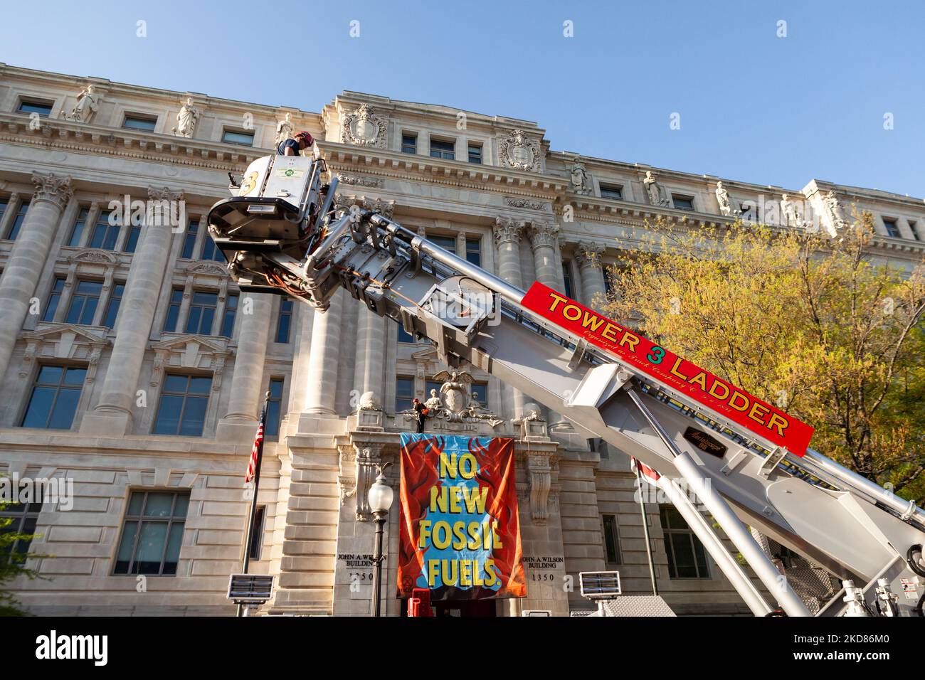 DC Fire uses a ladder truck to reach a member of Extinction Rebellion ...