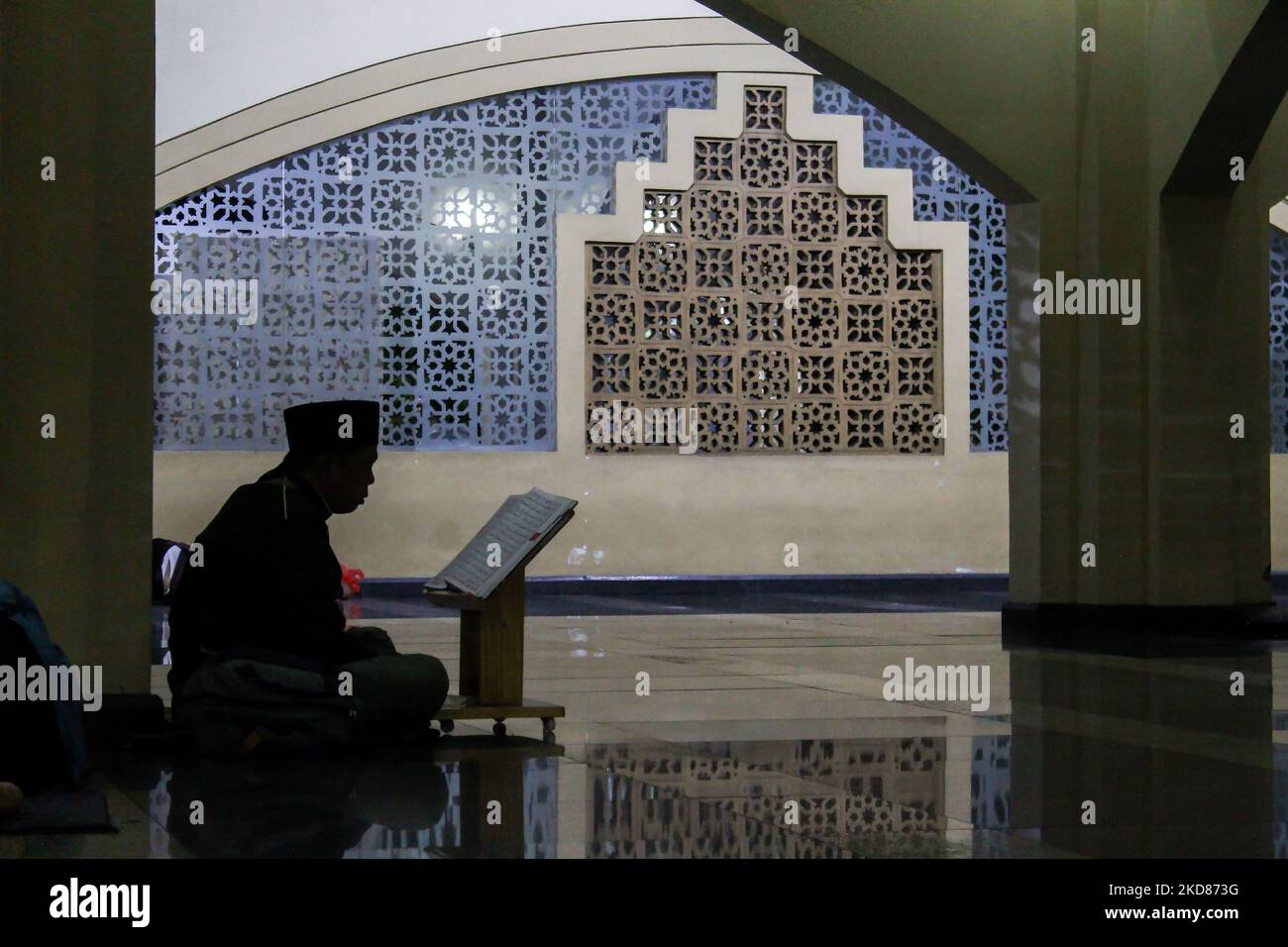 Muslims read the Quran during I'tikaf (staying in a mosque to pray) to ...