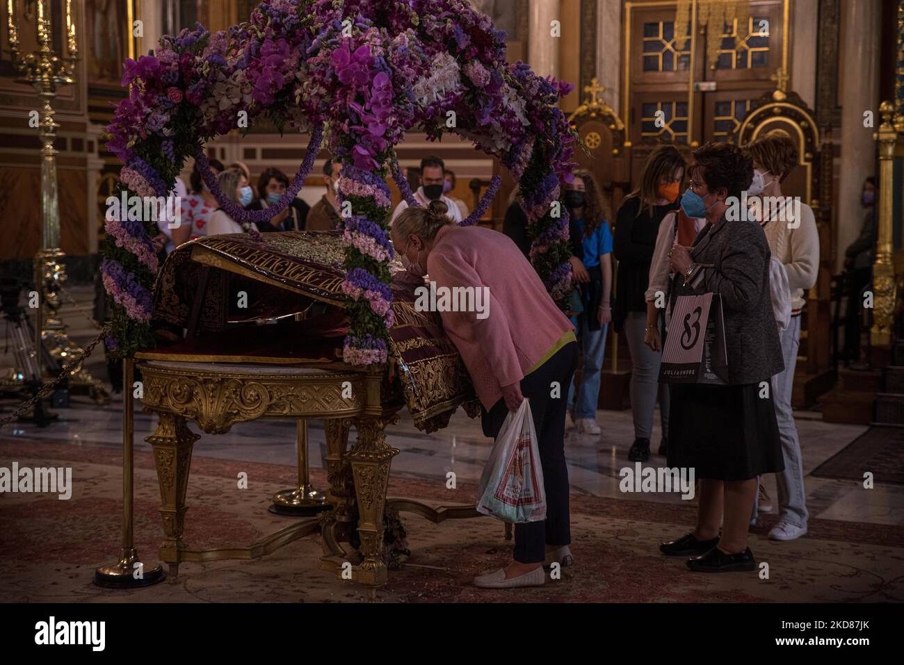 Athens, Greece, April 22nd, 2022 - A senior woman bends before the ...