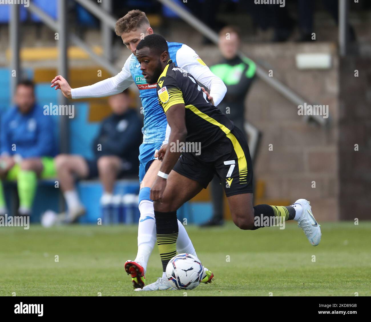 Barrow's Patrick Brough in action with Sutton United's David Ajiboye ...