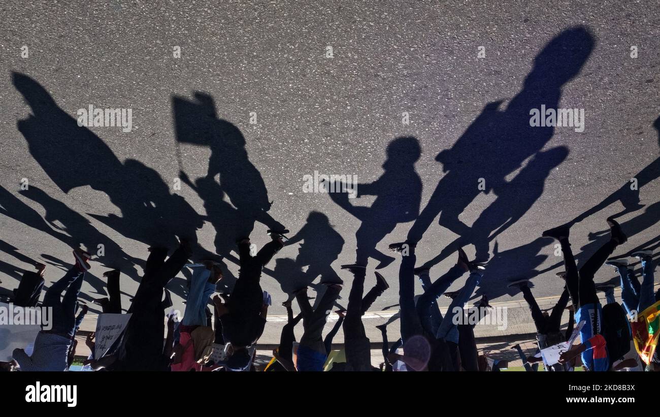 Shadows of the SrI Lankan protesters cast on the road as they protest ...