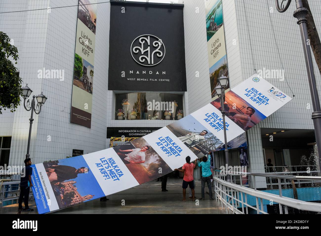 Workers are seen hanging banners of KIFF at Nandan fil center in ...