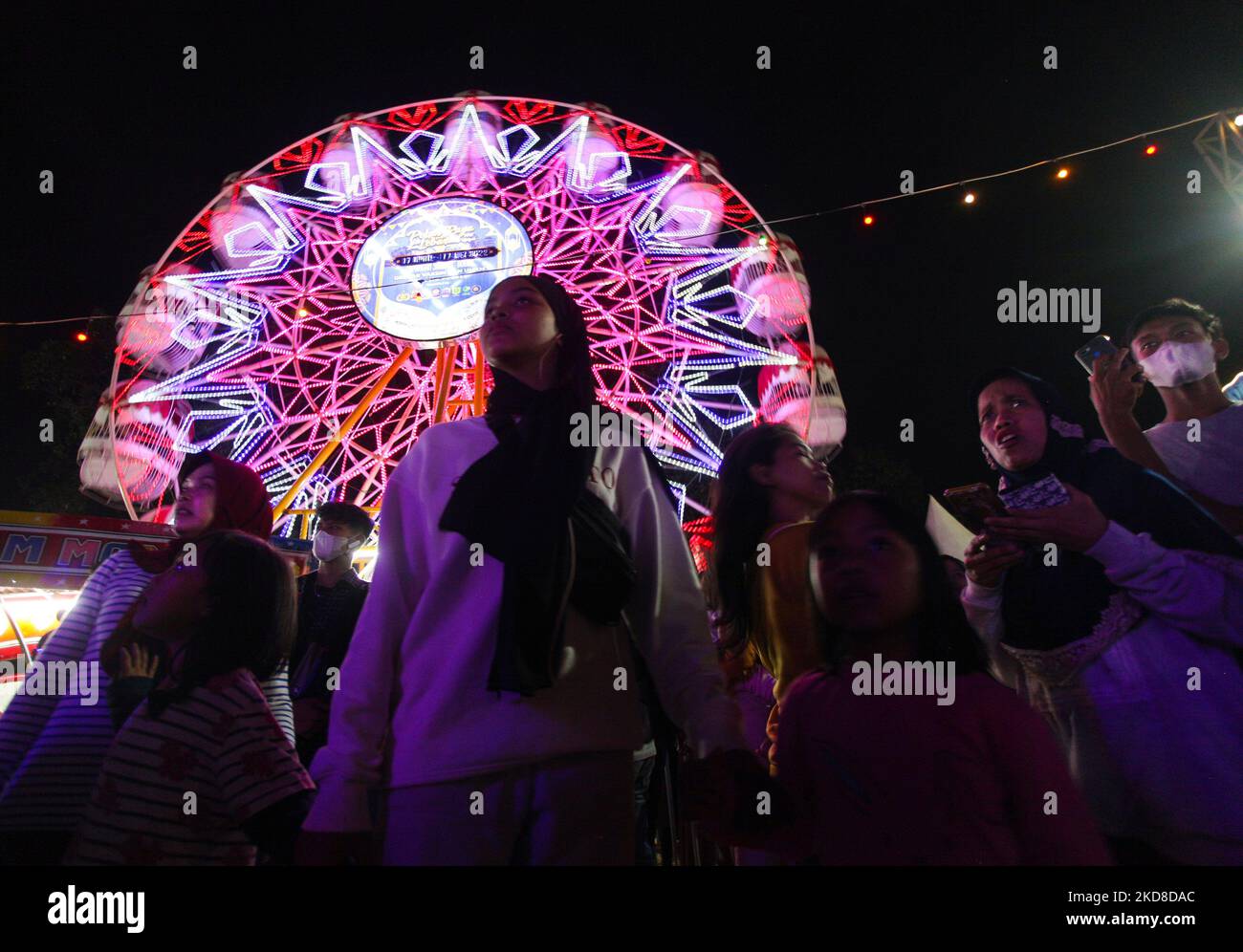 People enjoy rides at the Night Market during the Islamic holy month of ...