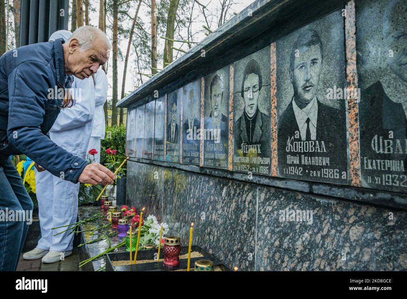 A man put a candle in the memorial of the dead workers in the ...