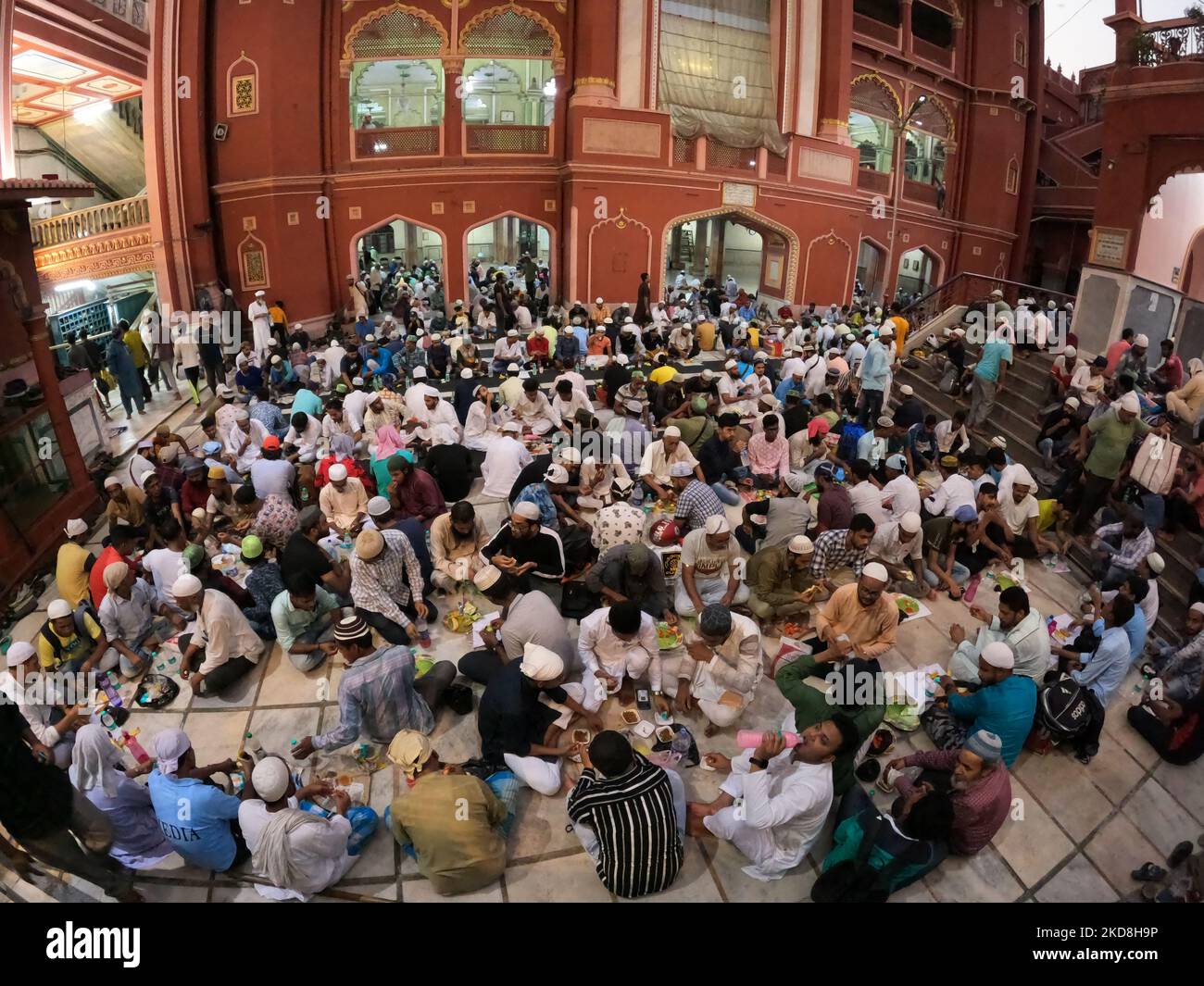 Muslims break their fast at the Nakhoda Masjid mosque during Islam's ...