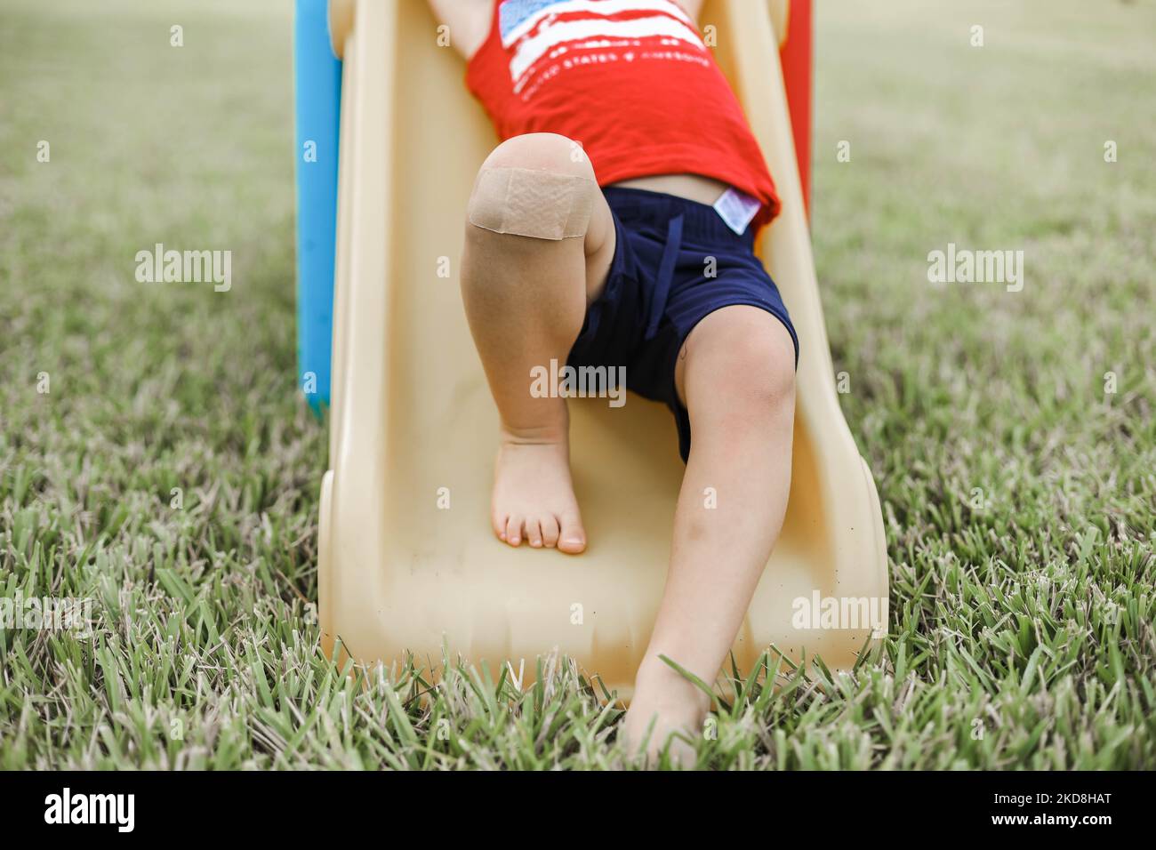 A barefoot child on a slide Stock Photo - Alamy