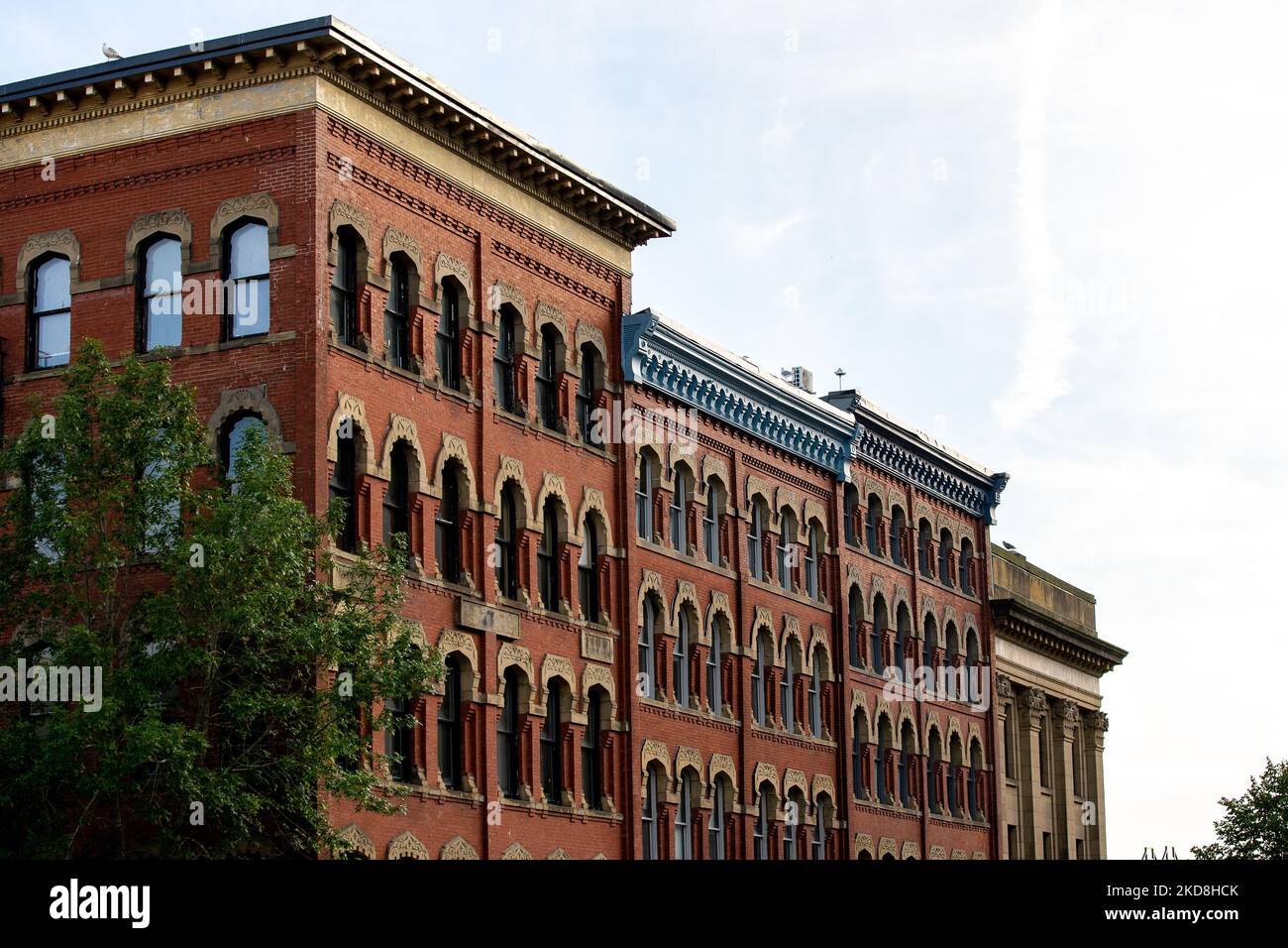 The red old brick buildings lined up on the street on a white ...