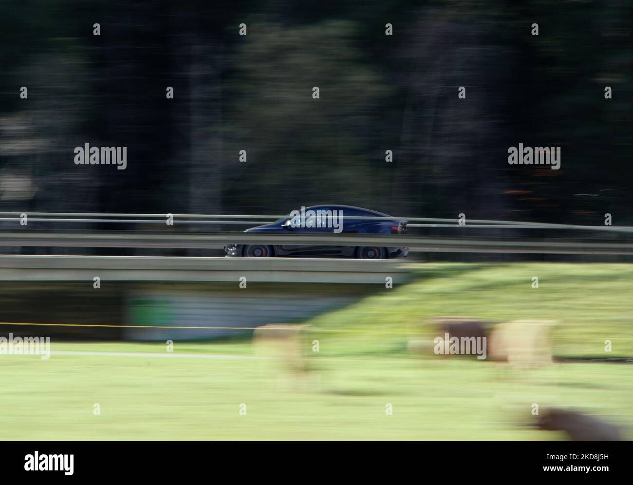 A long exposure shot of an epic black tesla model 3 car driving at high ...