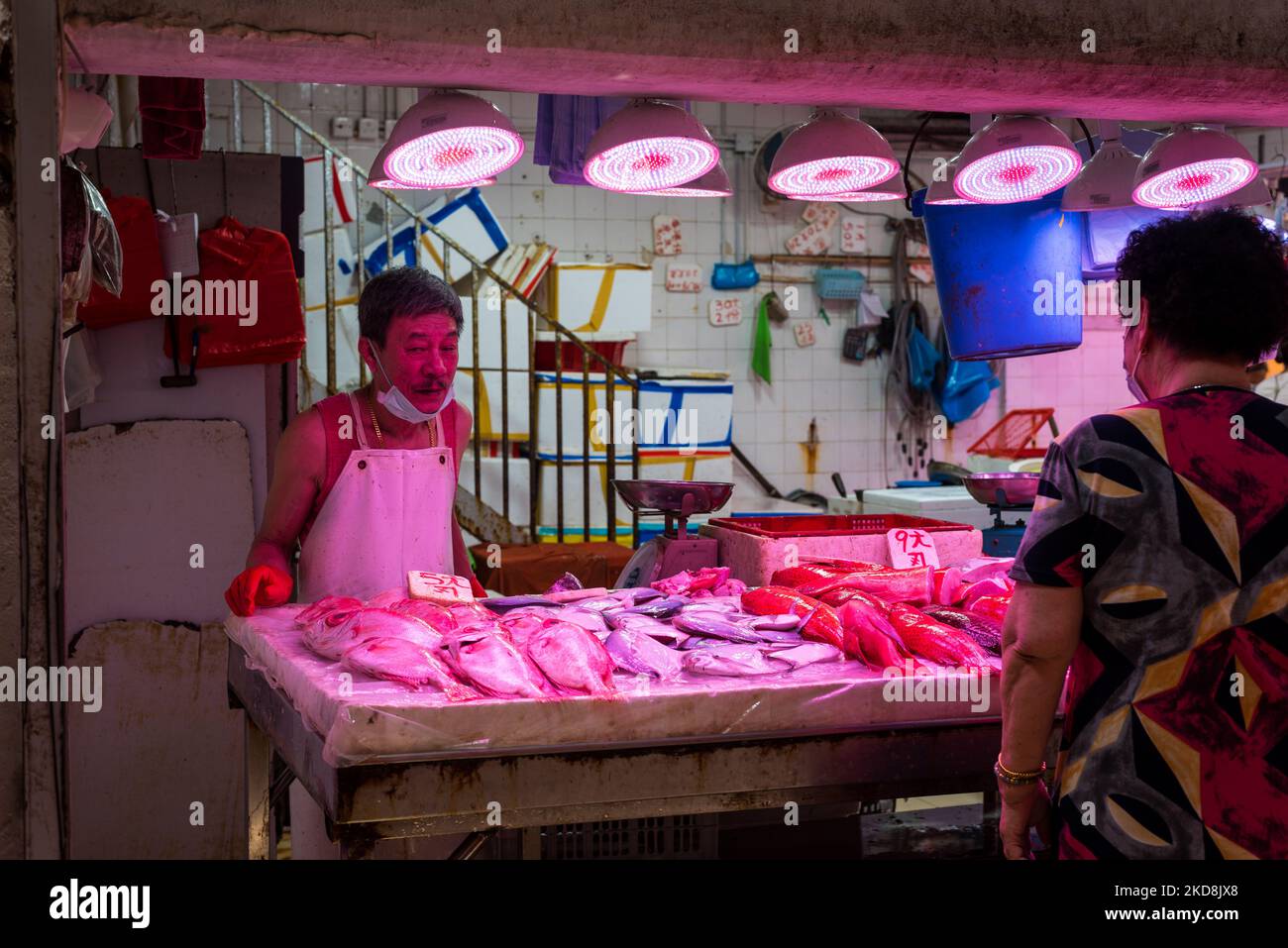 Hong Kong, China, 28 Apr 2022, A fishmonger stands behind his stall on ...