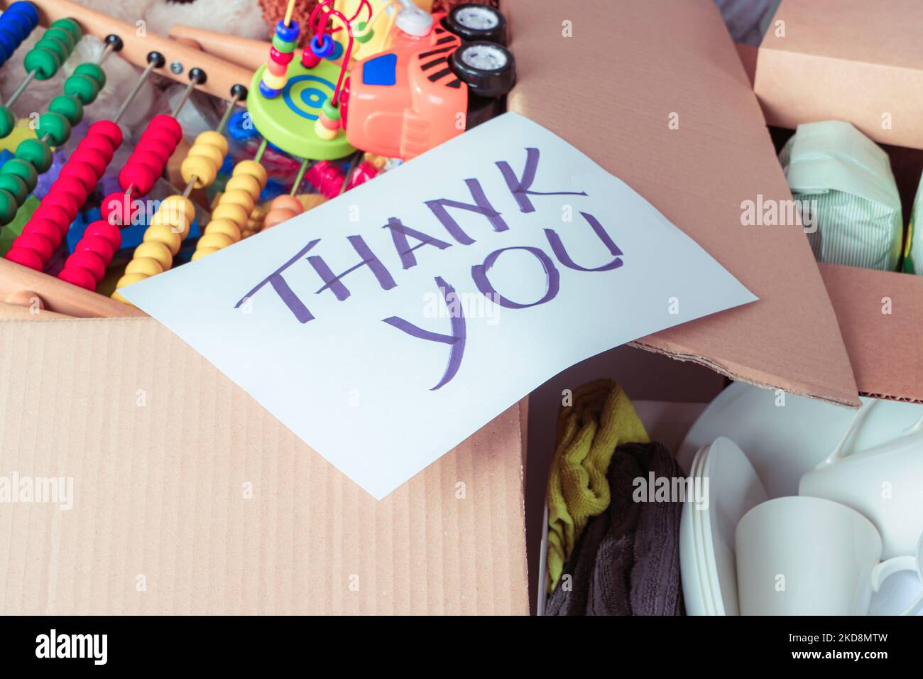 Donations boxes with kid toys, clothes, dishes, household items ...