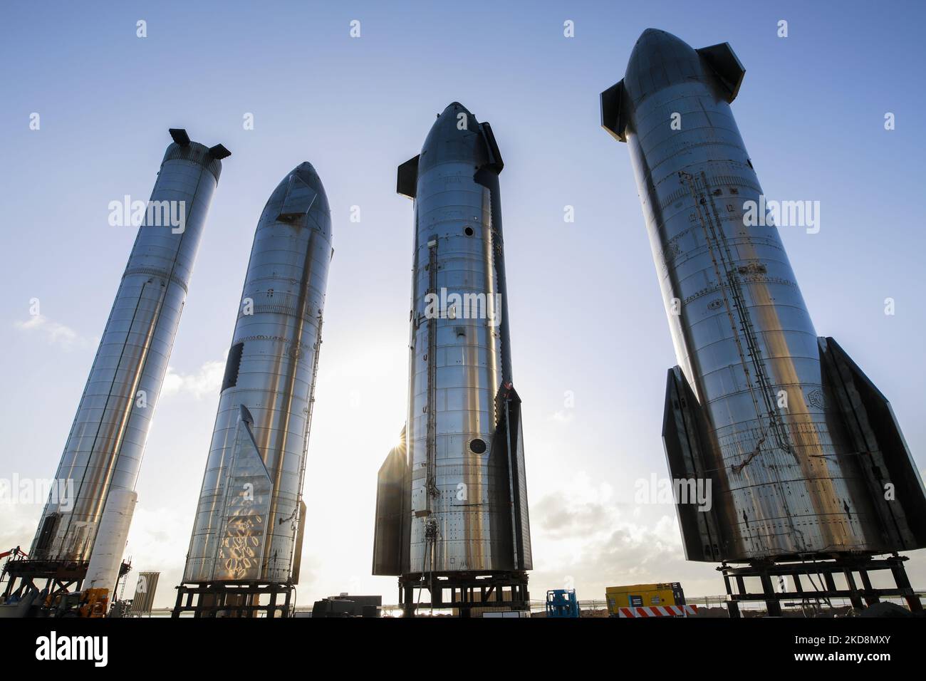 Booster 5, SN15, SN22, and SN16 stand behind the build site at SpaceX's ...