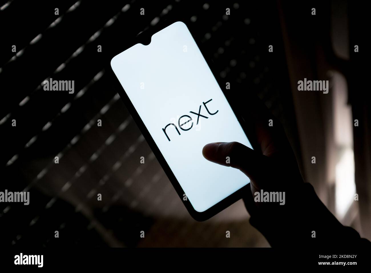 In this photo illustration a Next plc logo seen displayed on a ...