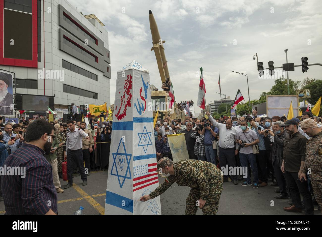 An Islamic Revolutionary Gurd Corps (IRGC) military personnel burns the ...