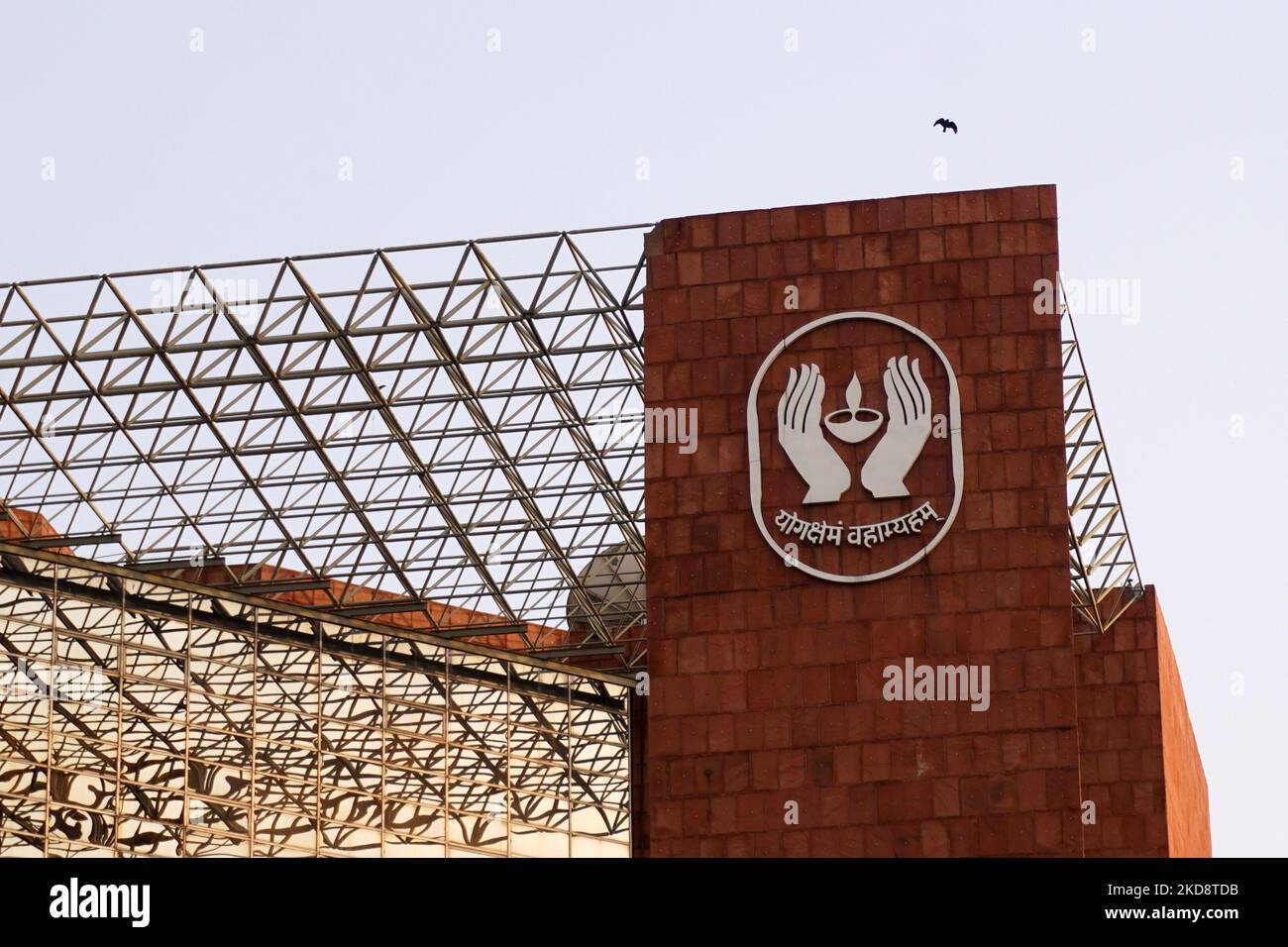 A bird flies past a logo of Life Insurance Corporation of India (LIC ...