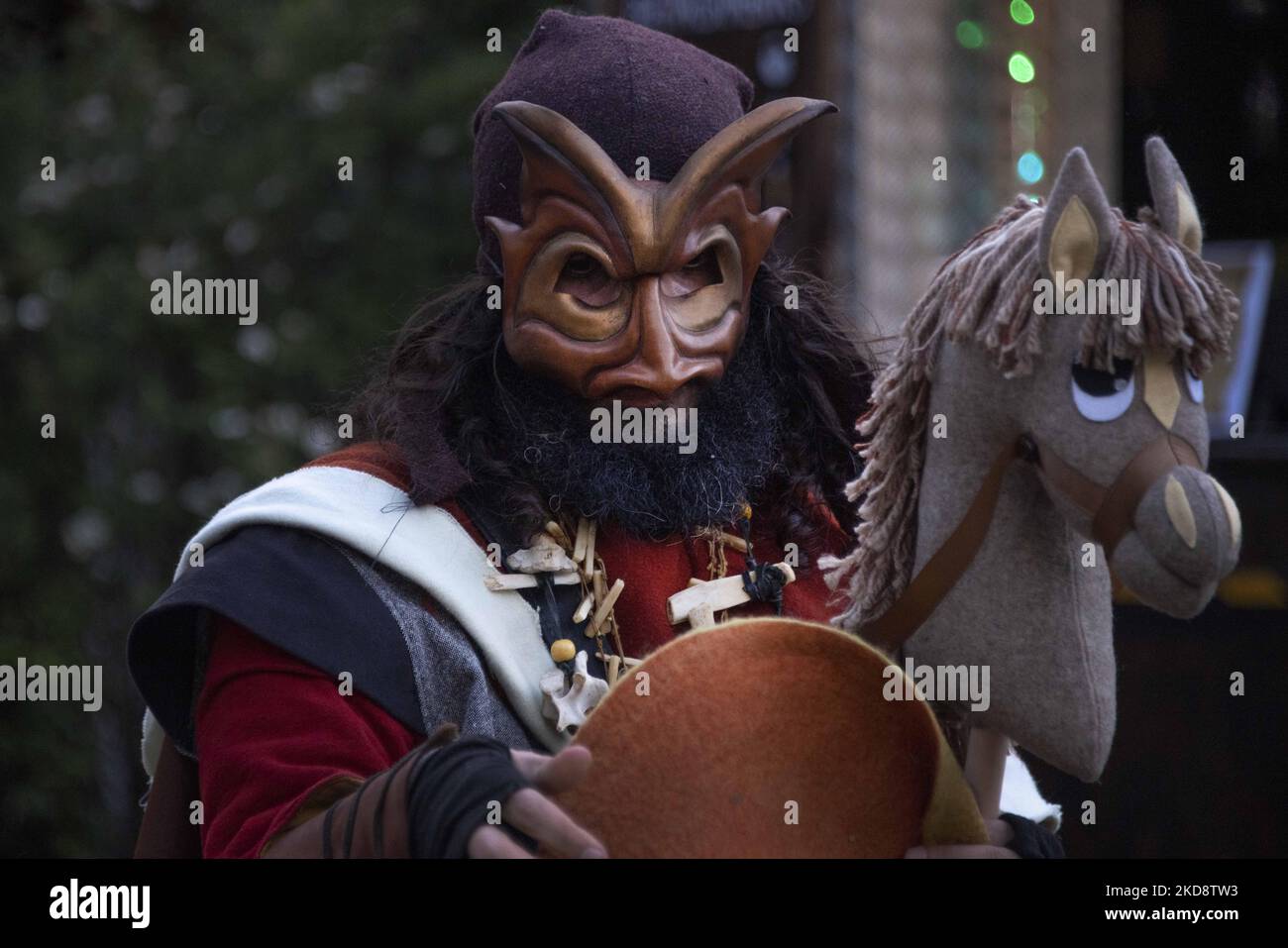A jester with his toy horse is seen amusing the attendees of a medieval ...