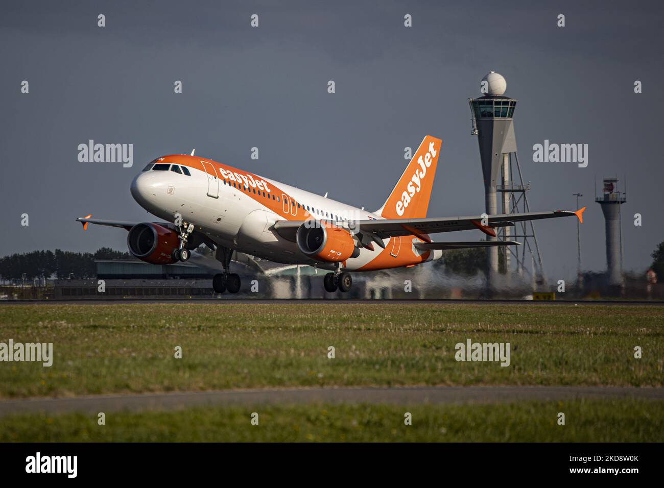 Airplane is flying in front of the control tower. EasyJet Europe Airbus ...