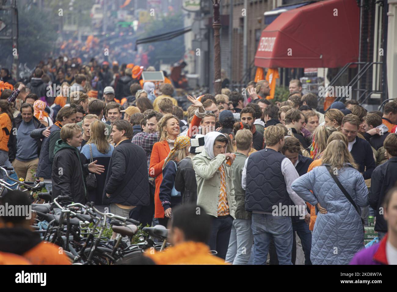 Crowds of people wearing mainly orange clothes and having the Dutch ...