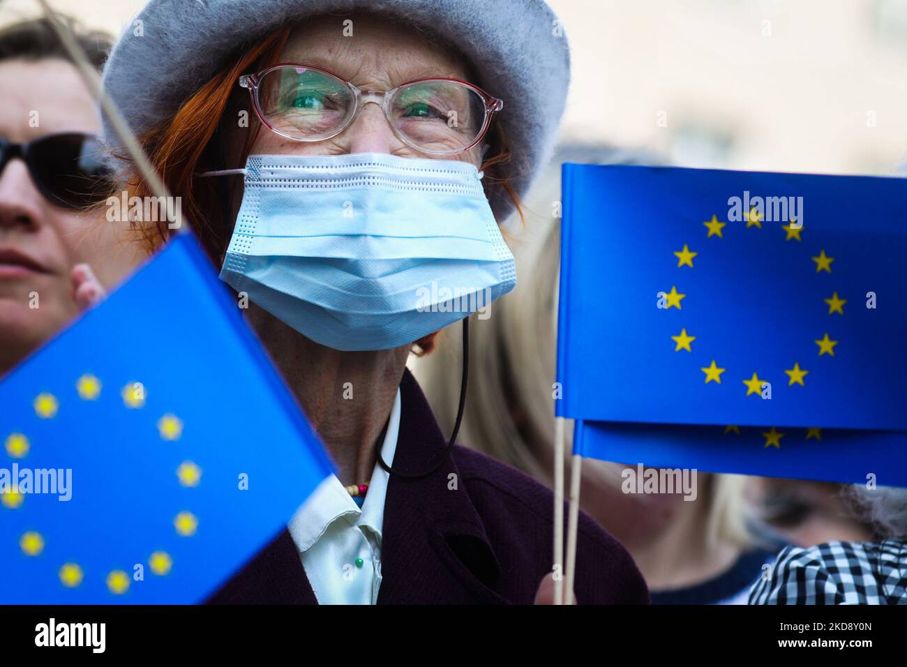 A woman wearing a face masks while holding EU flag during celebration ...