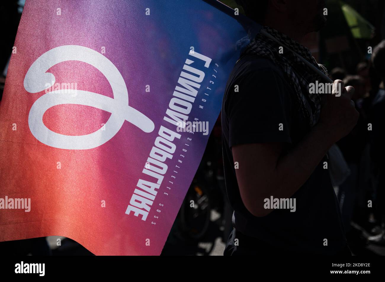 A demonstrator holds up a flag of the political party La France ...