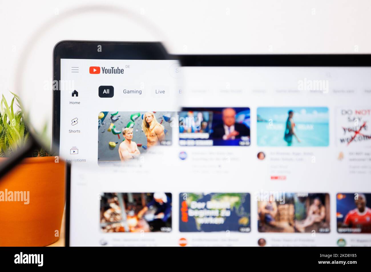 A Youtube Logo under a magnifying glass. Youtube Website on Laptop ...