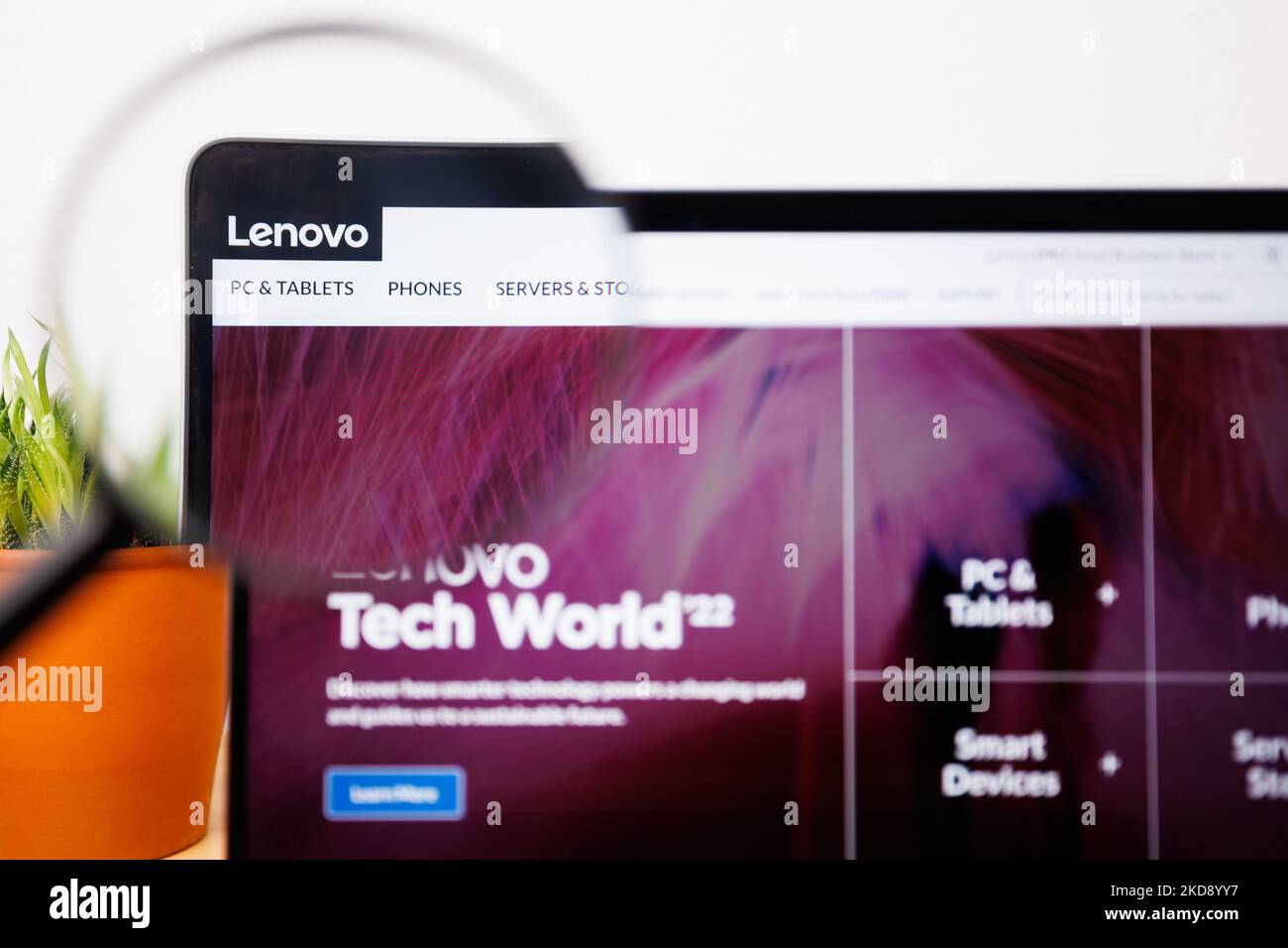 A lenovo Logo under a magnifying glass. lenovo Website on Laptop screen ...