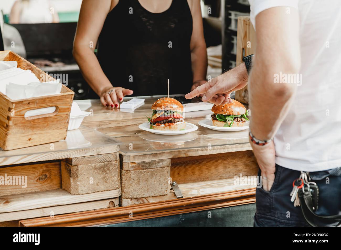Man chooses burgers at a burger feast. Dinner Hamburger Food Feast ...