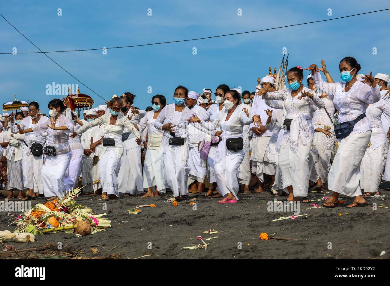 Balinese Hindu devotees gather as they perform prayers during the ...