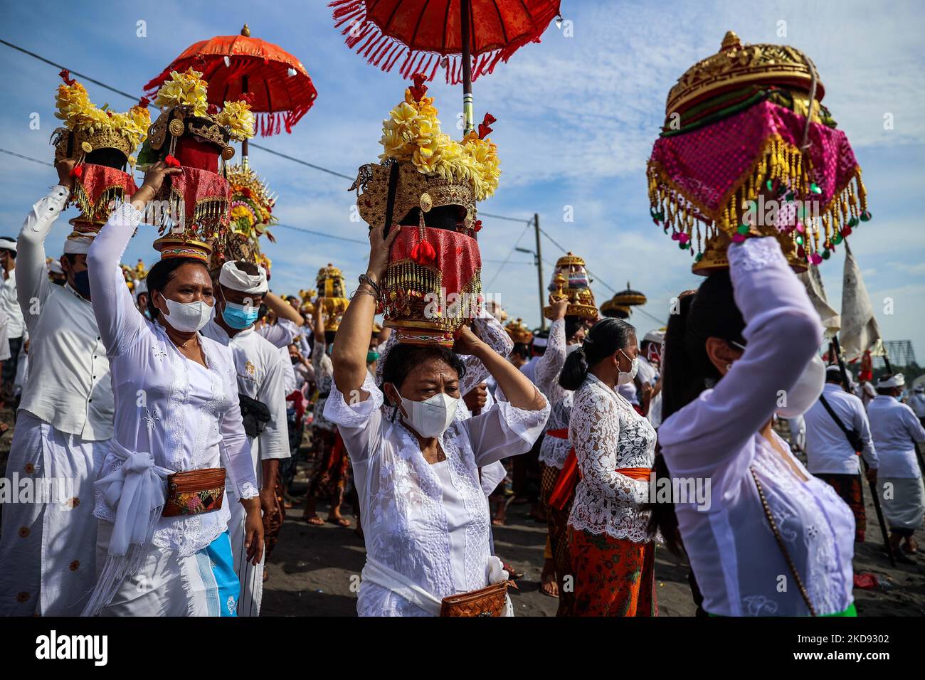 Balinese Hindu devotees carry offerings during the Melasti, a ...
