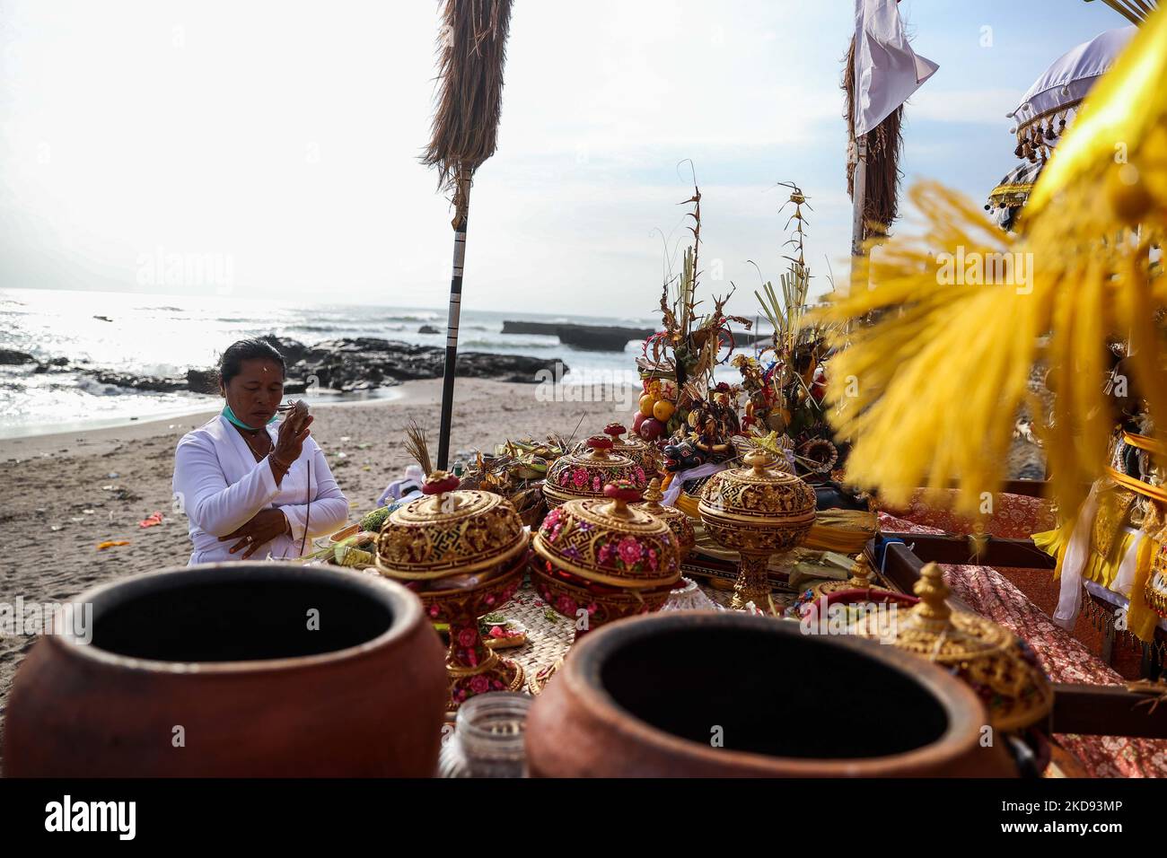 A Balinese Hindu woman pray during the Melasti, a purification ceremony ...