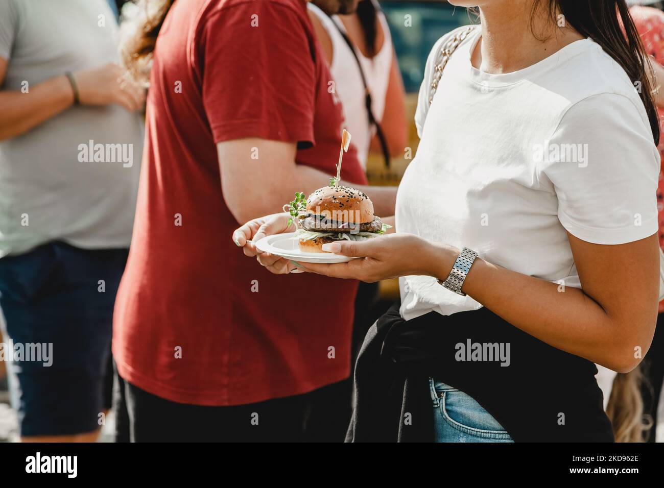 Woman holds in his hand burgers at a burger feast. Dinner Hamburger ...