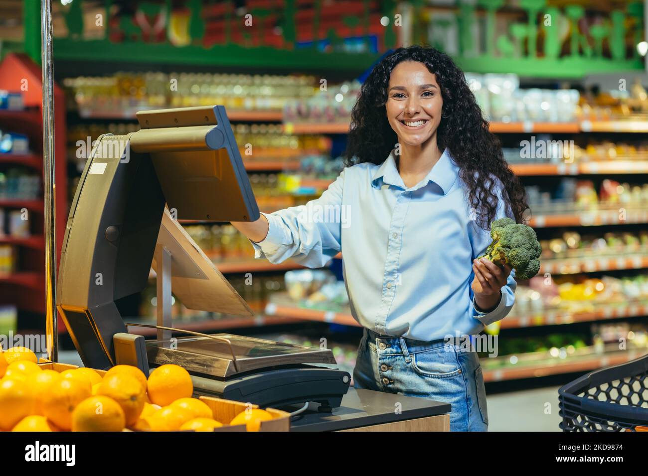 Portrait of a happy shopper in a supermarket in the fruit and vegetable ...