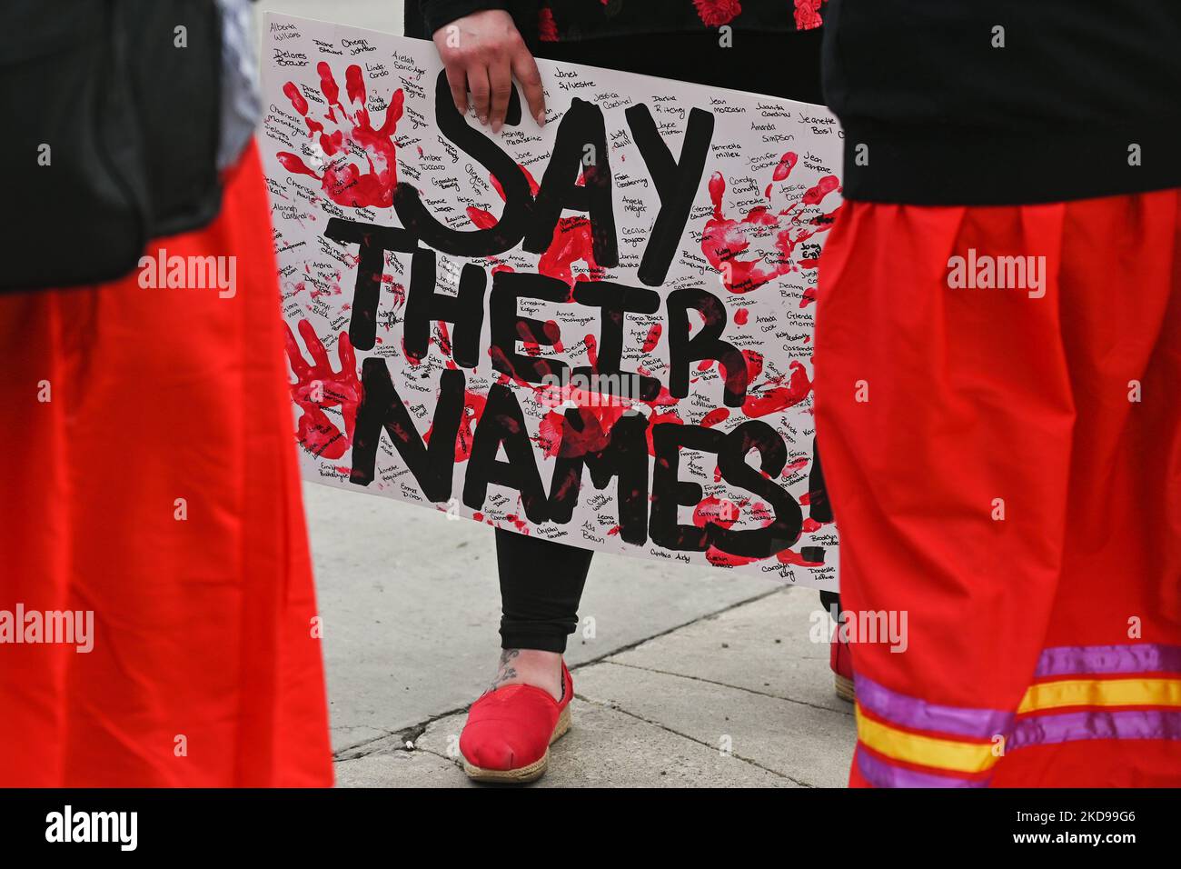 A participant holds a placard with words 'Say Their Names'. Hundreds of ...