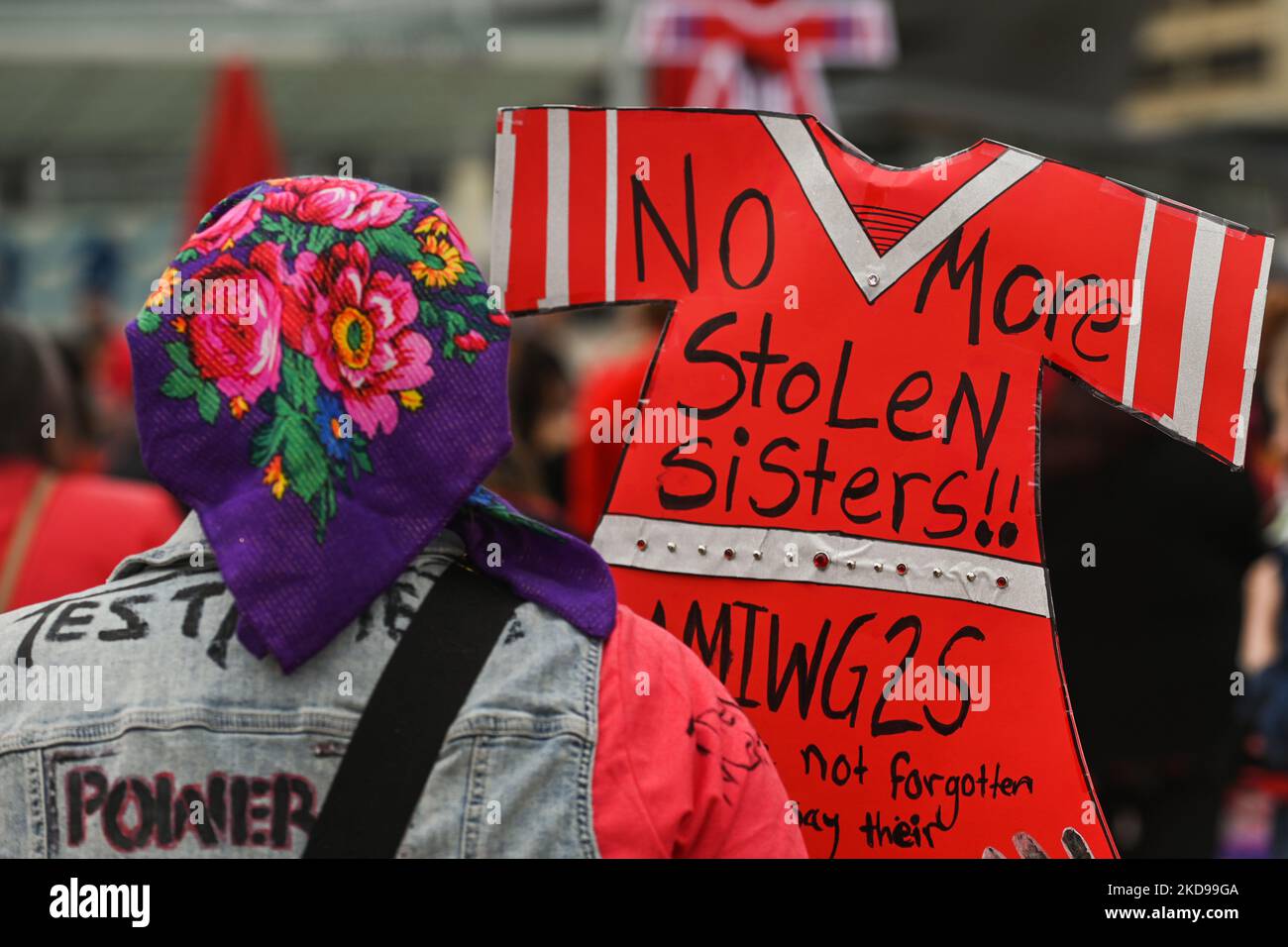 A participant holds a placard with words 'No More Stolen Sisters!!'. Hundreds of women ...