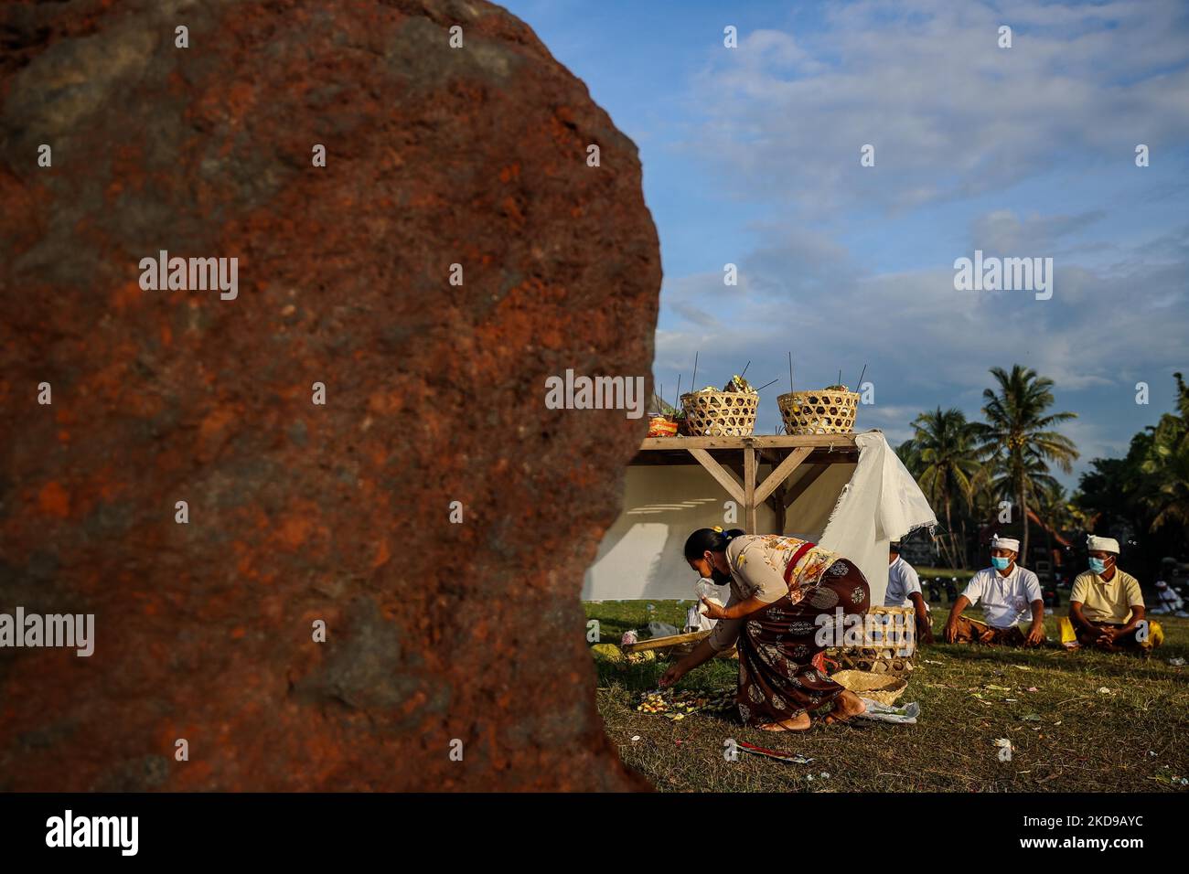 Balinese Hindu devotees gather as they perform prayers during the ...