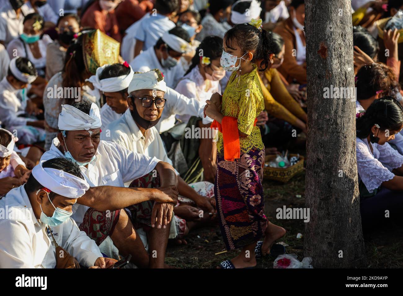 Balinese Hindu devotees gather as they perform prayers during the ...