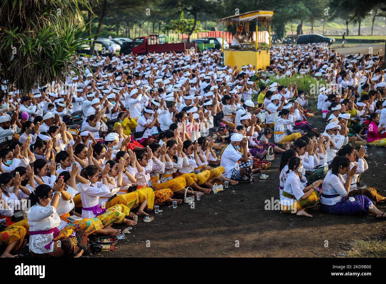 Balinese Hindu devotees gather as they perform prayers during the ...