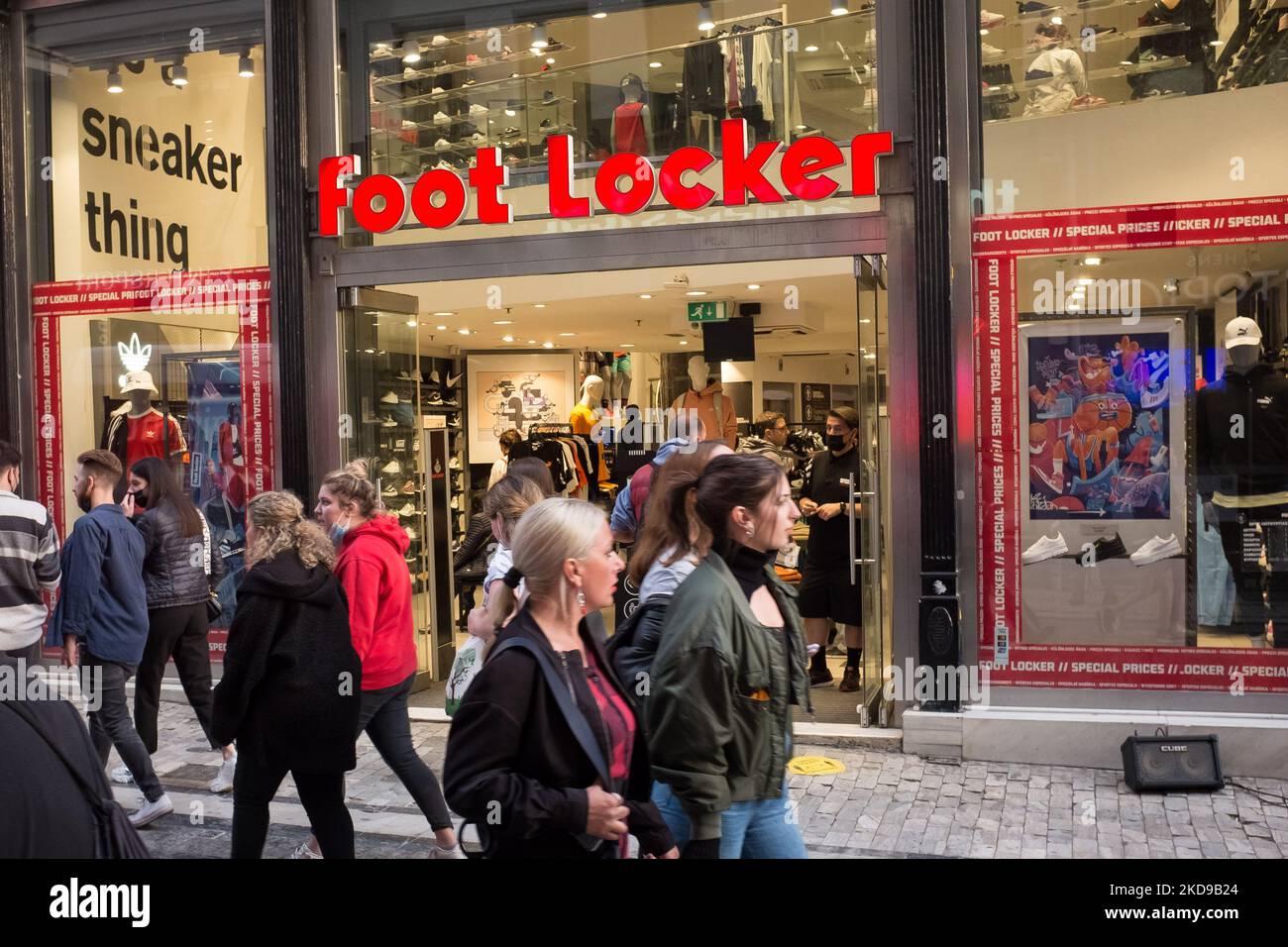 People are passing in front of a Foot Locker store at Ermou street in ...