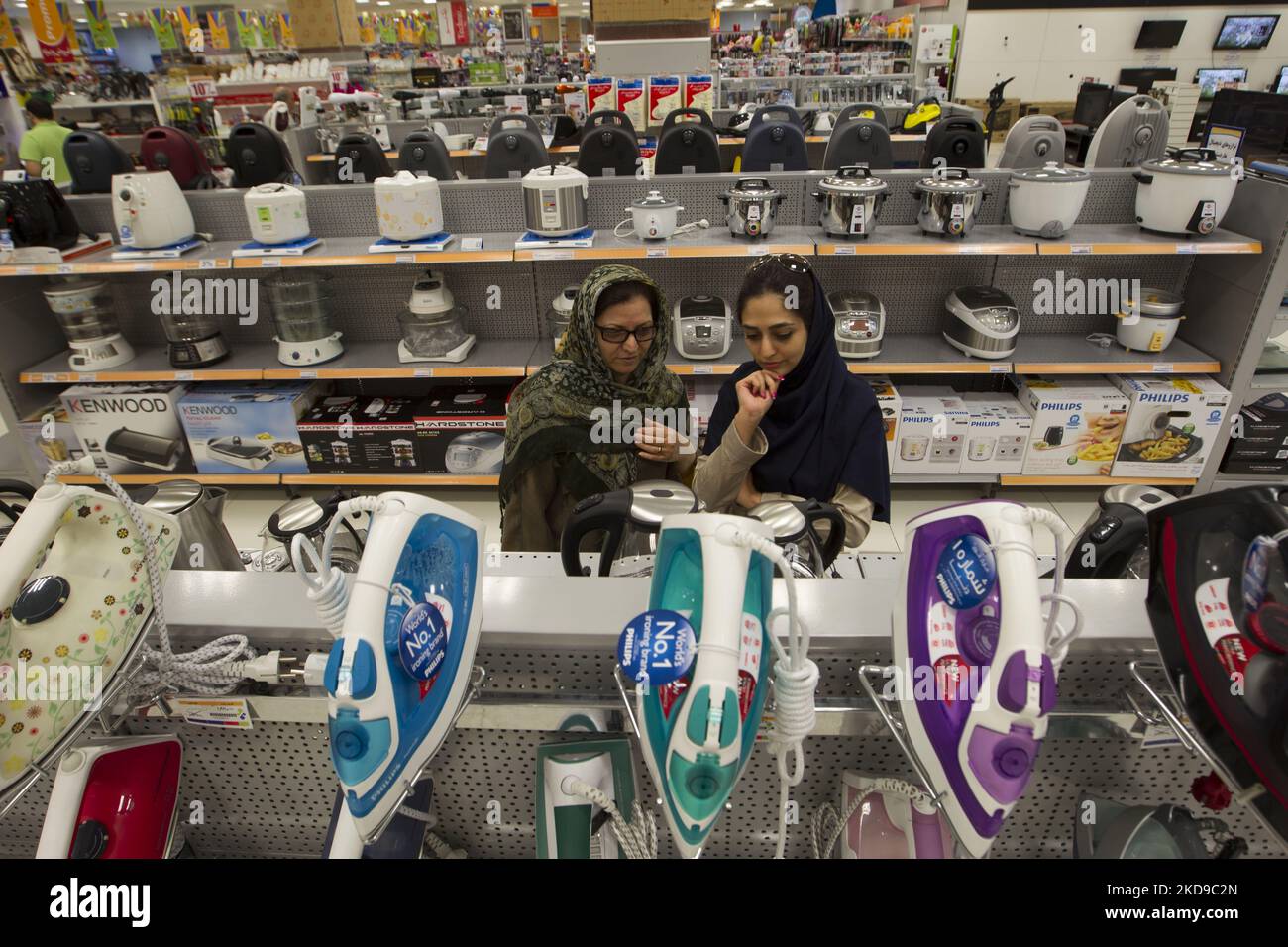 Two Iranian women look at home equipments while shopping in Tehran's ...
